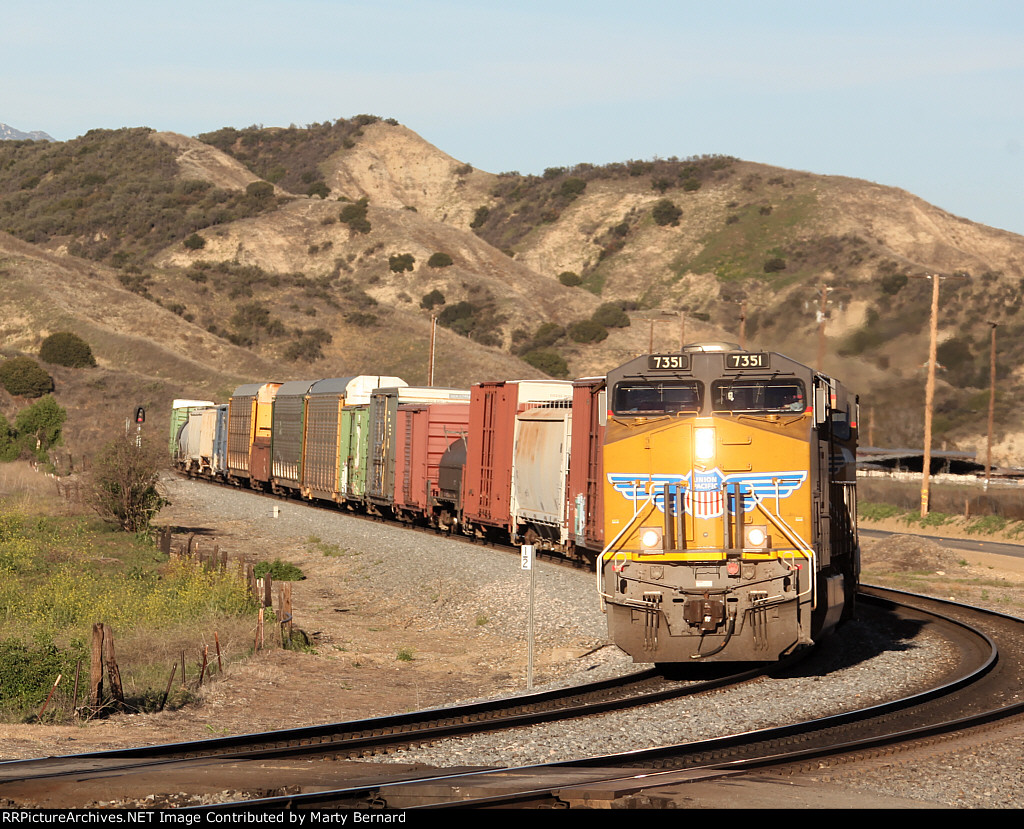 UP 7351 Rolls Down Hill With Mixed Freight